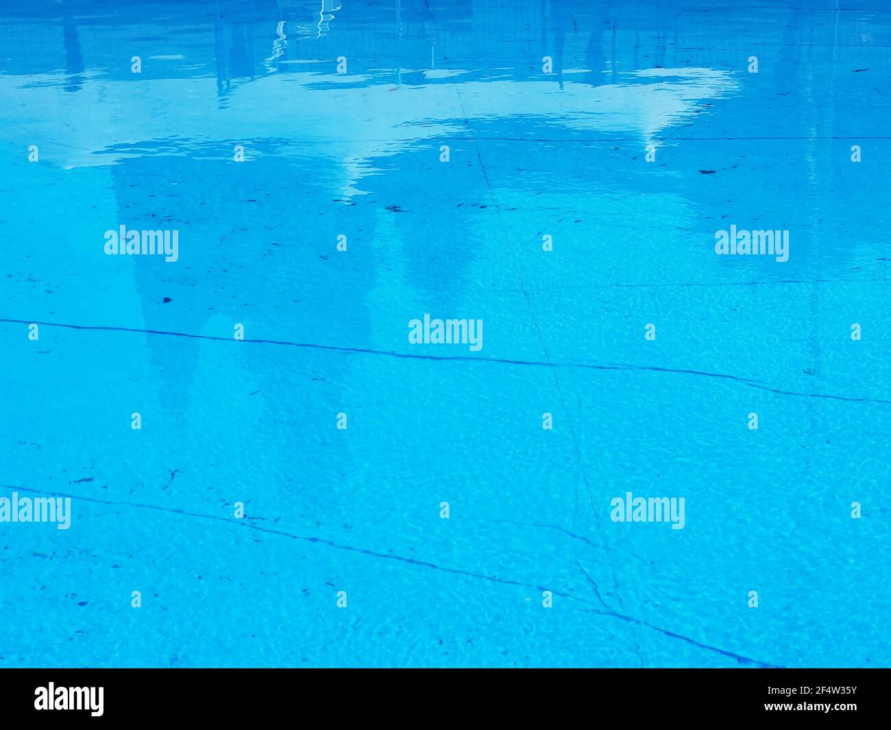 Water in blue pool with spots and streaks at the bottom. Full screen ...