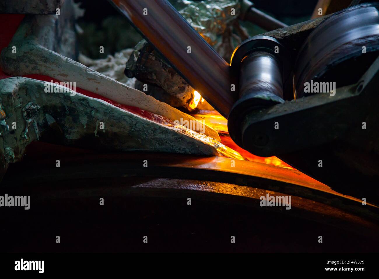 Closeup of aluminium wire rod production machine. Melted liquid ...