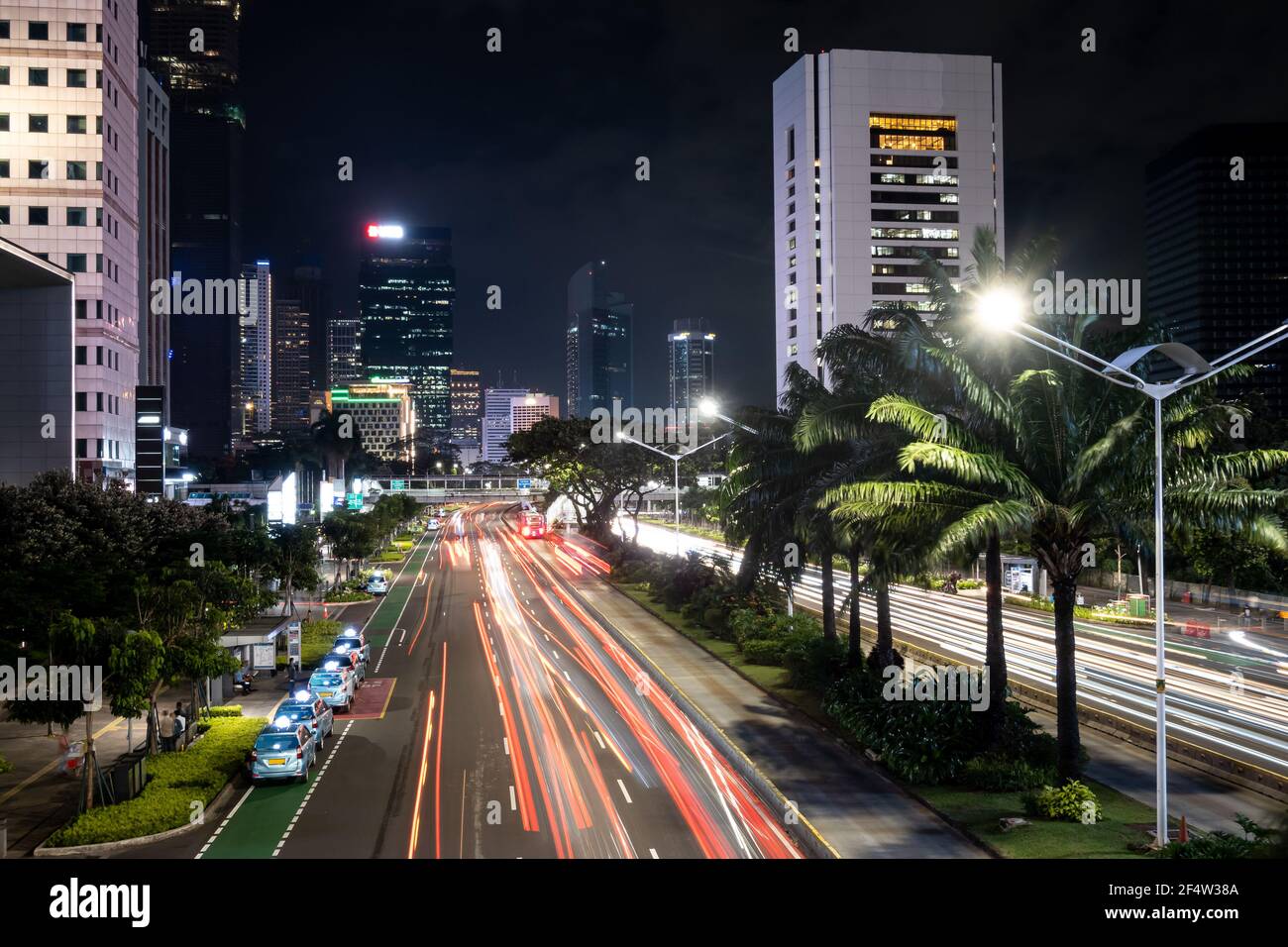 Traffic light trails in the modern business district in Jakarta ...