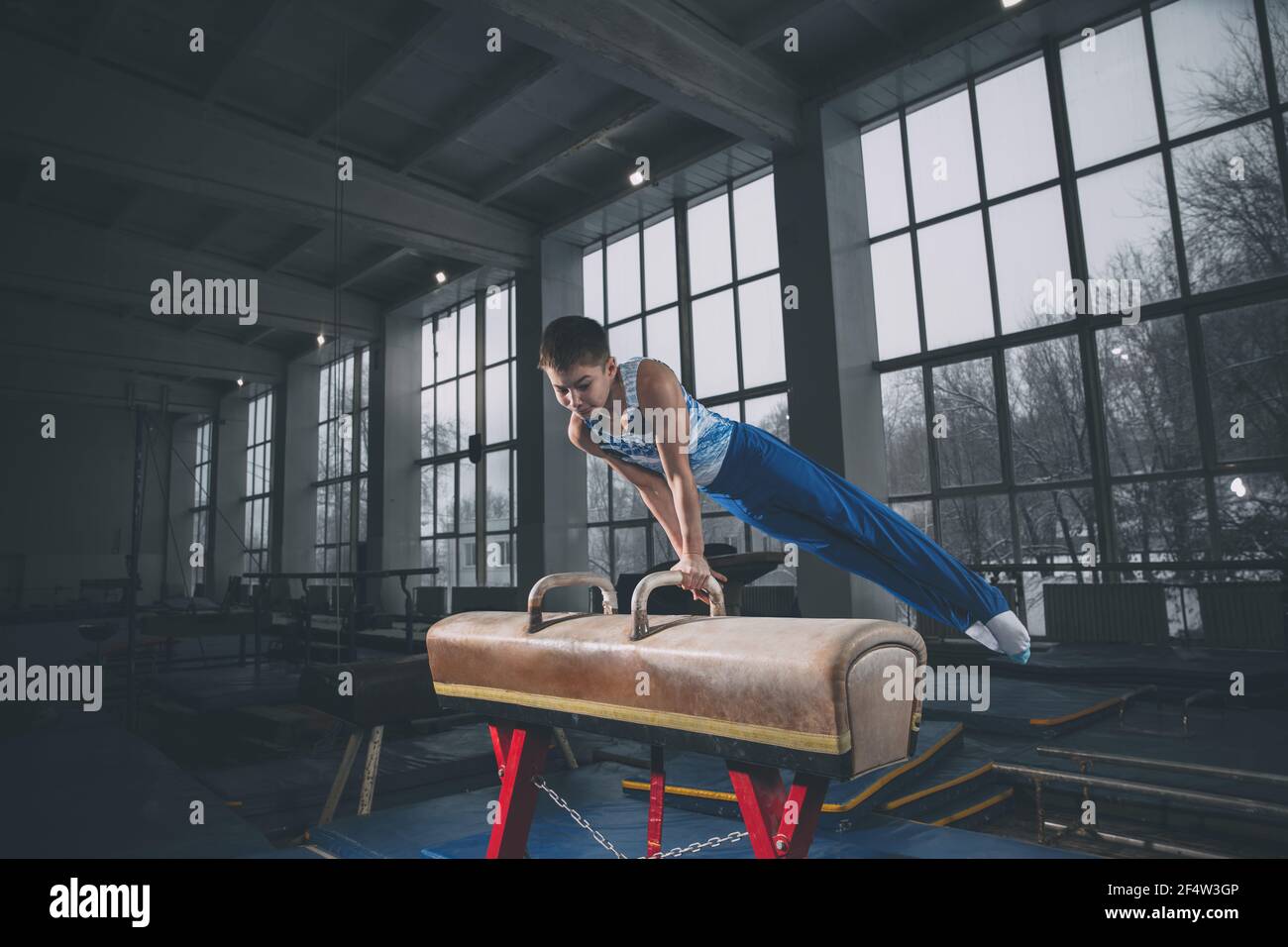 Little male gymnast training in gym, flexible and active. Caucasian fit ...