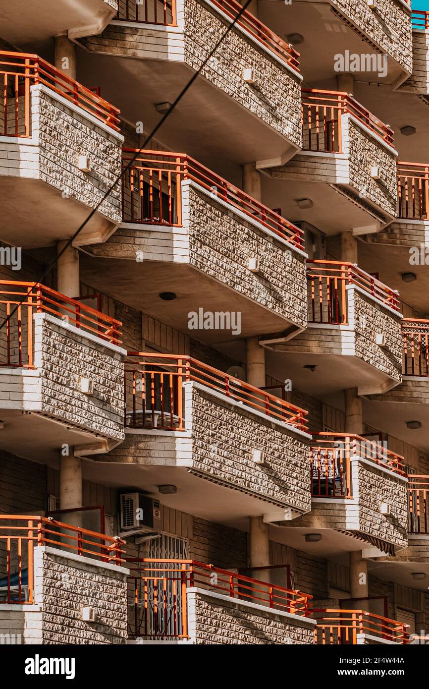 Vertical of a beautiful contemporary high rise building with balconies ...