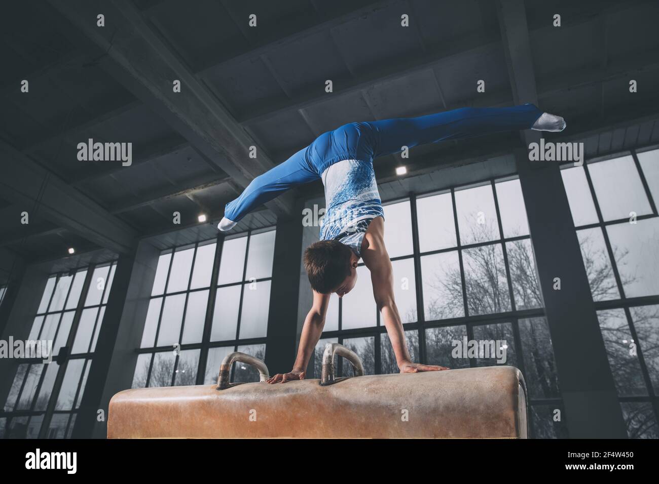 Little male gymnast training in gym, flexible and active. Caucasian fit ...