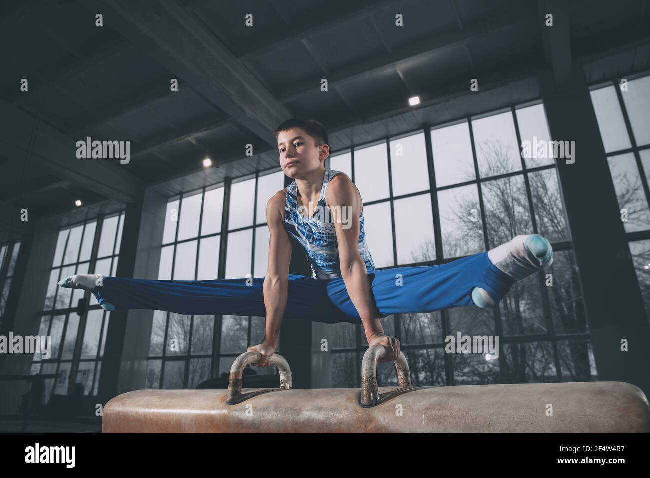 Little male gymnast training in gym, flexible and active. Caucasian fit ...