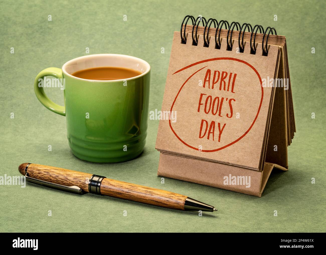 April Fools' Day -handwriting in a desktop calendar with a cup of ...
