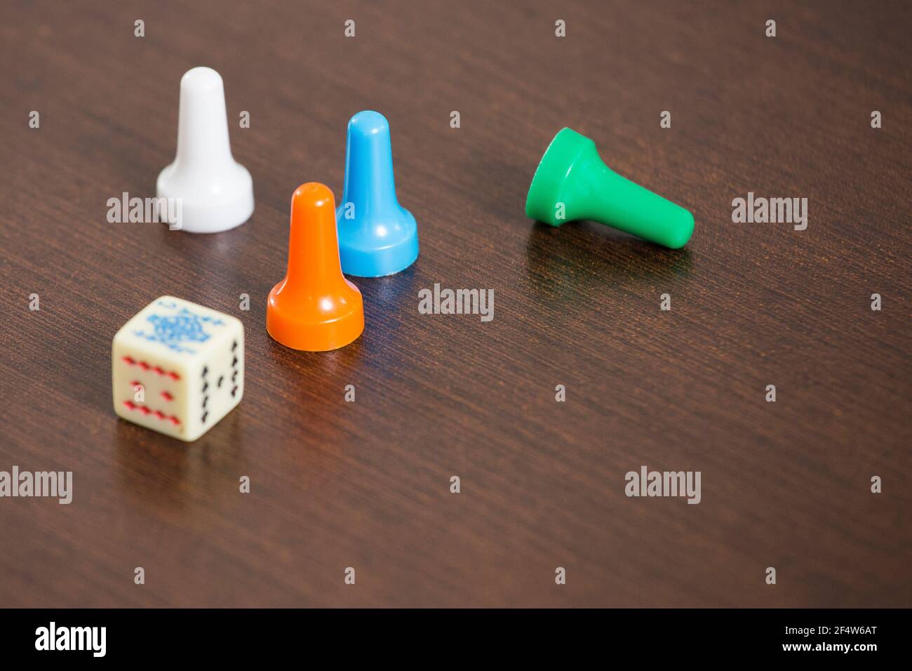 Colorful game pieces and dice Stock Photo - Alamy