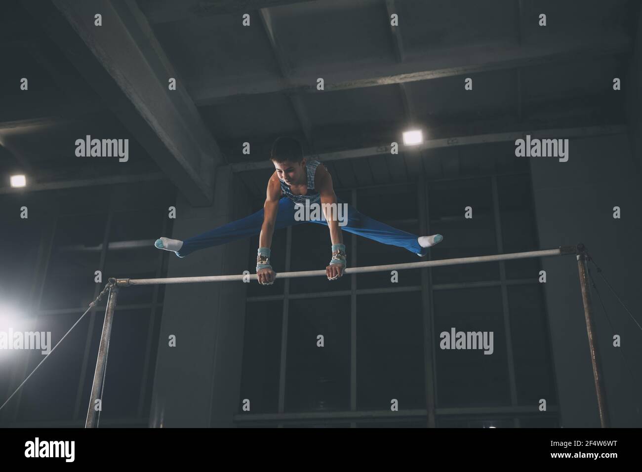 Little male gymnast training in gym, flexible and active. Caucasian fit ...