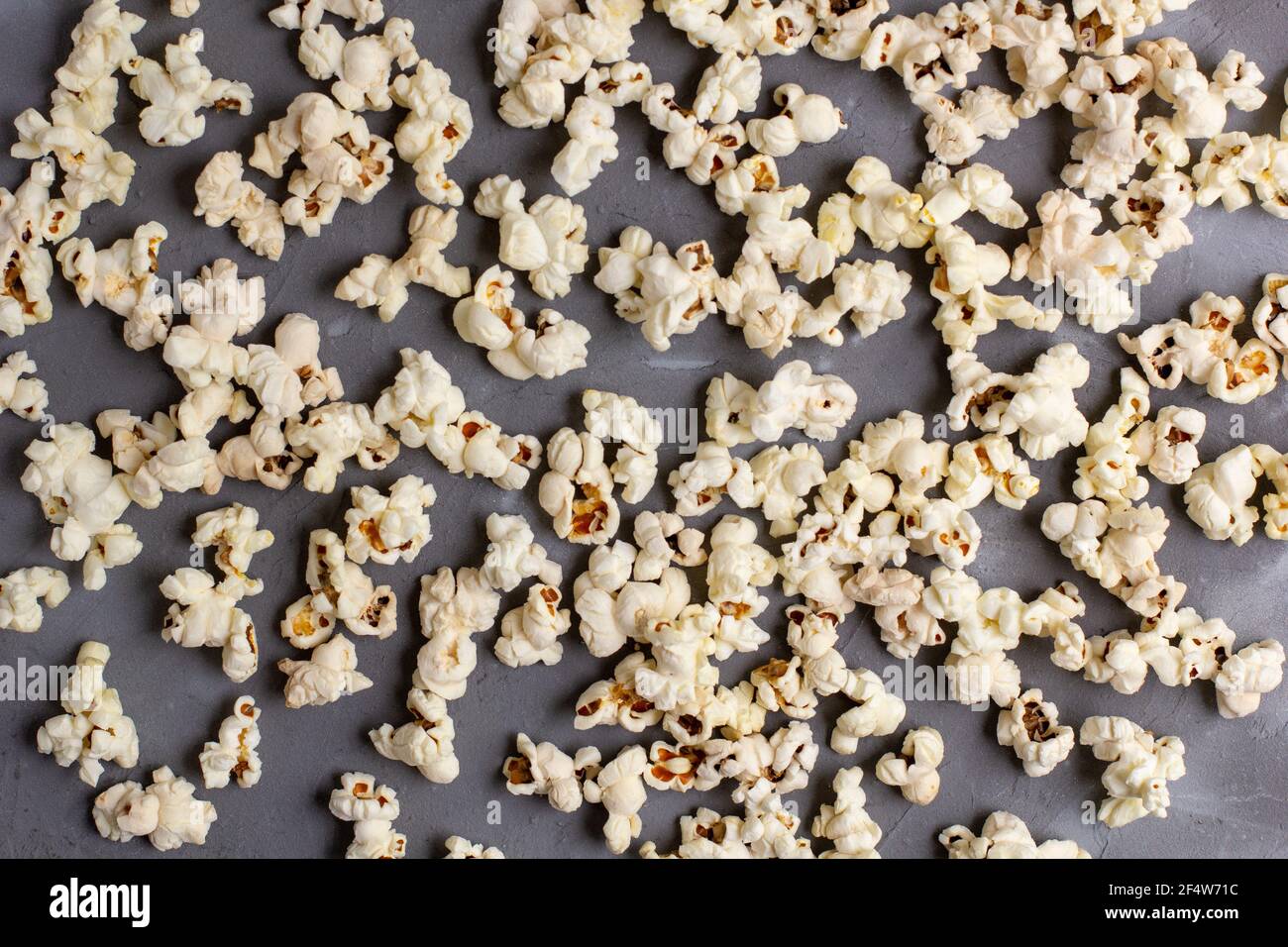 Popcorn pattern on grey stone background. Top view Stock Photo - Alamy