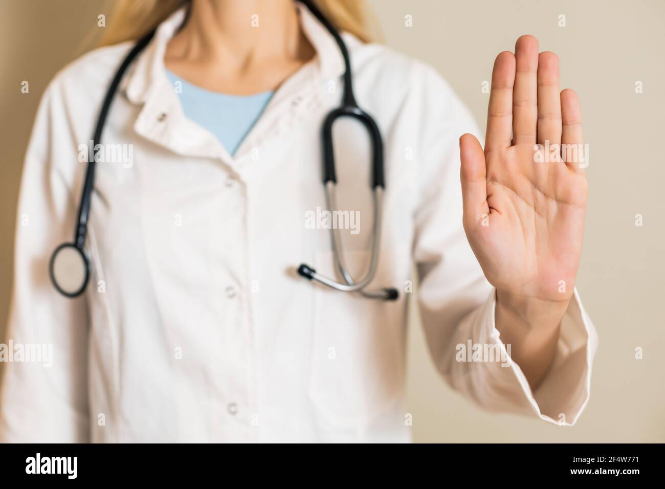 Image of female doctor showing stop sign Stock Photo - Alamy