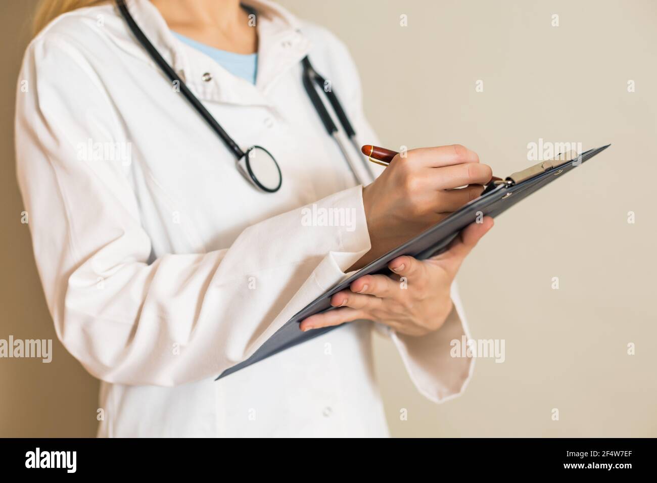 Image of female doctor writing notes Stock Photo - Alamy