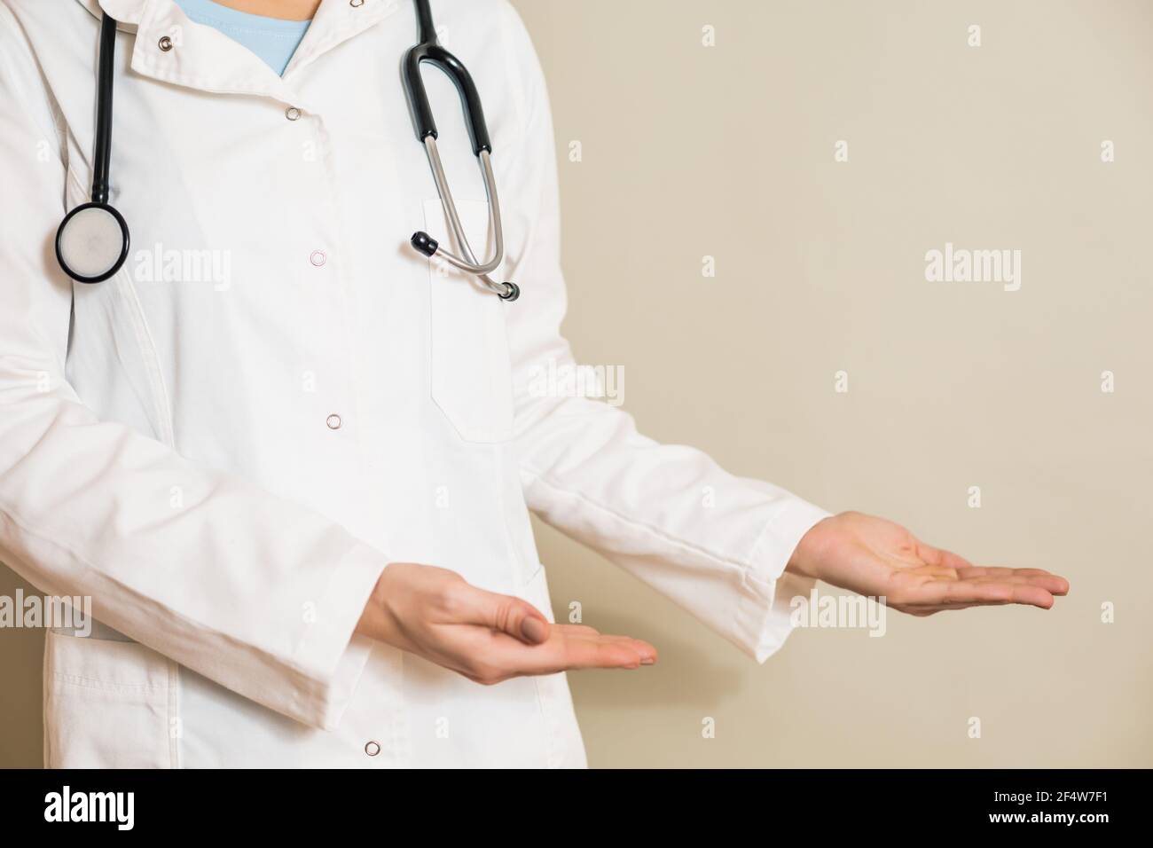 Image of female doctor showing showing welcome gesture Stock Photo - Alamy
