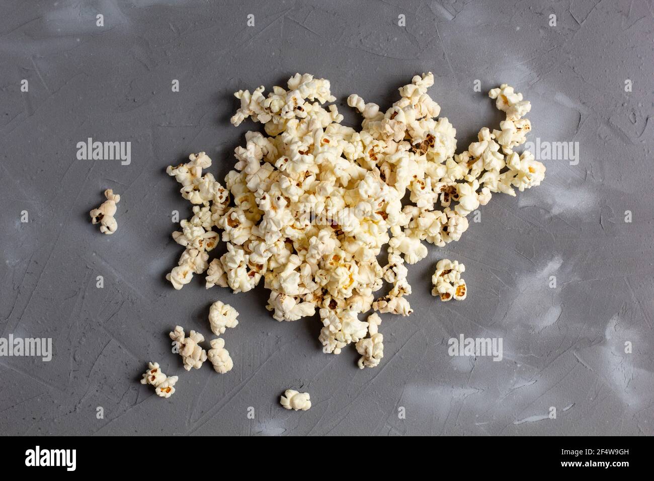 Pile of delicious fresh popcorn on grey stone background. top view ...