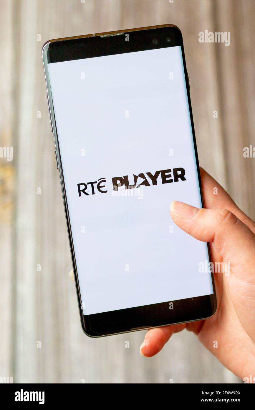 A mobile phone or cell phone being held in a hand with the RTE Player ...