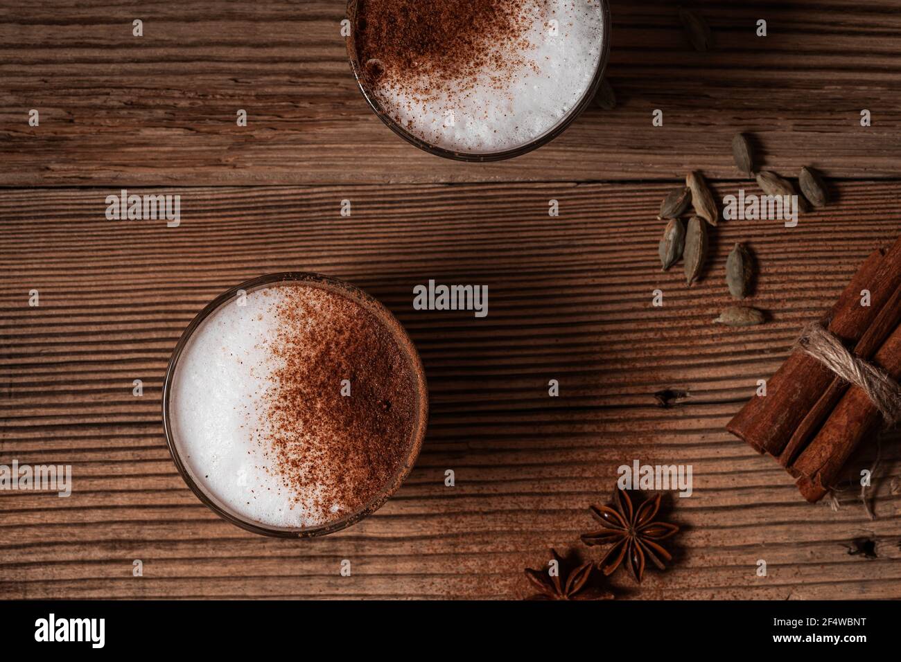 Glass of chai tea latte, hot latte foam garnish with ground cinnamon ...