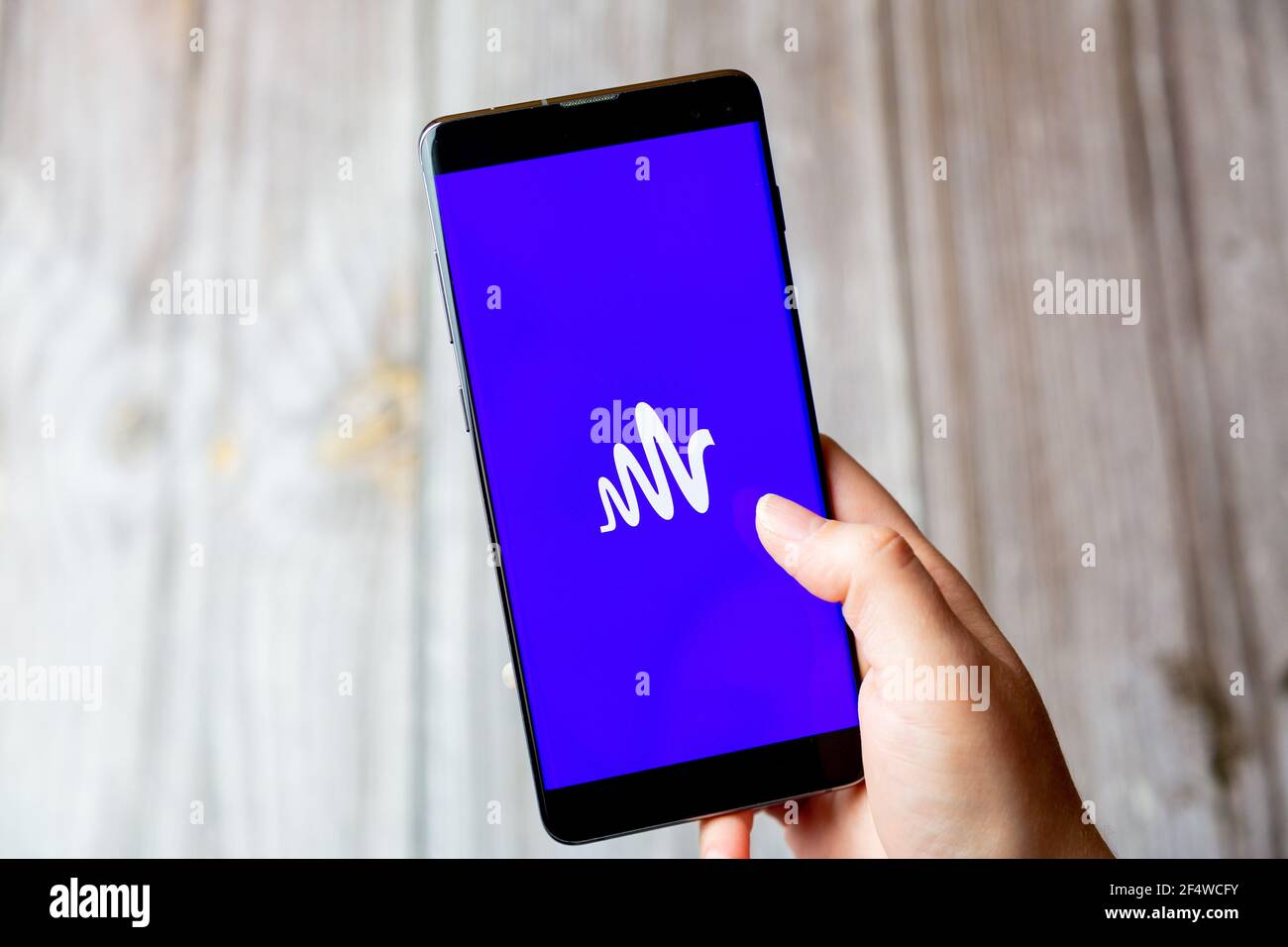 A mobile phone or cell phone being held in a hand with the Anchor ...