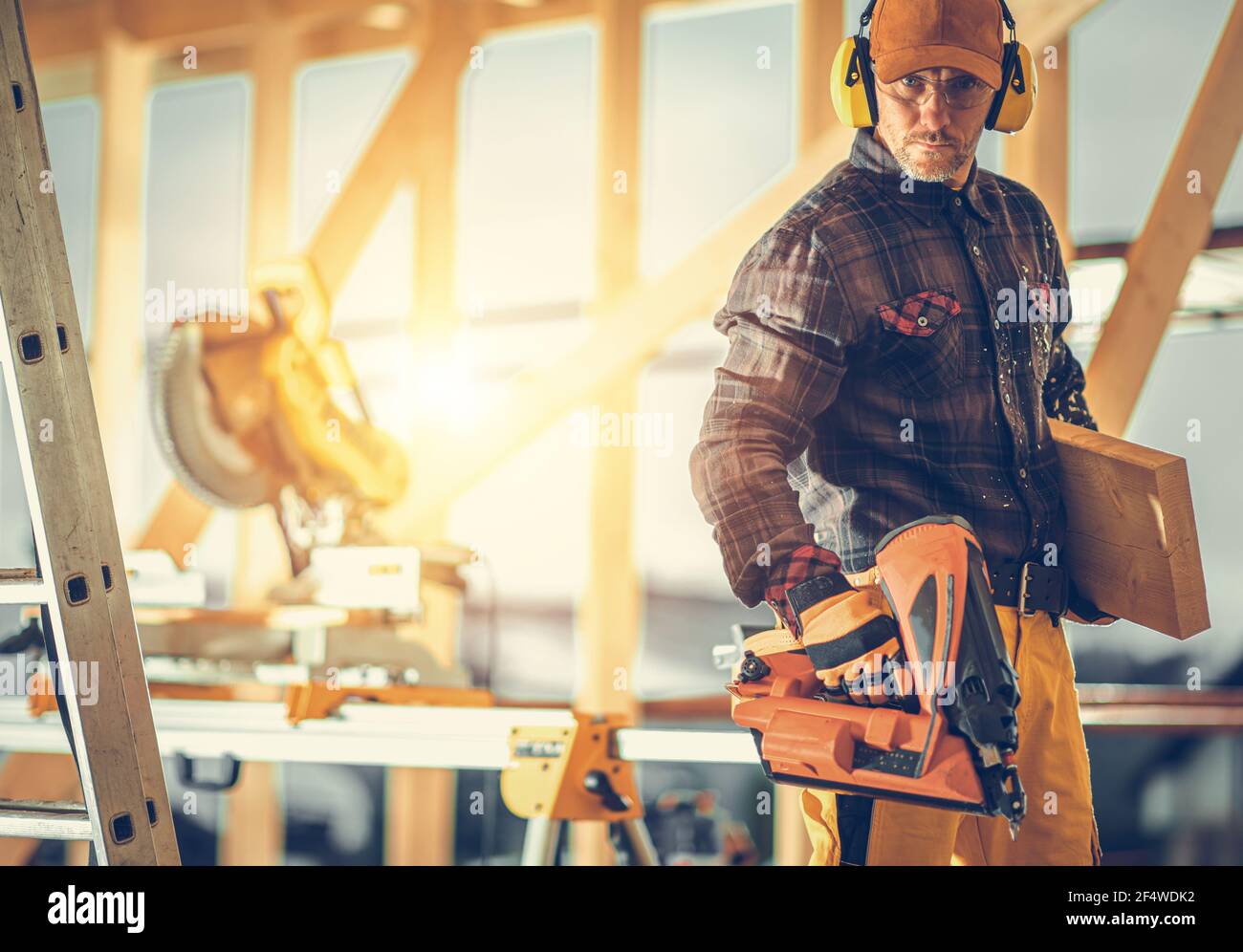 Caucasian Construction Contractor Worker in His 40s with Nail Gun in ...
