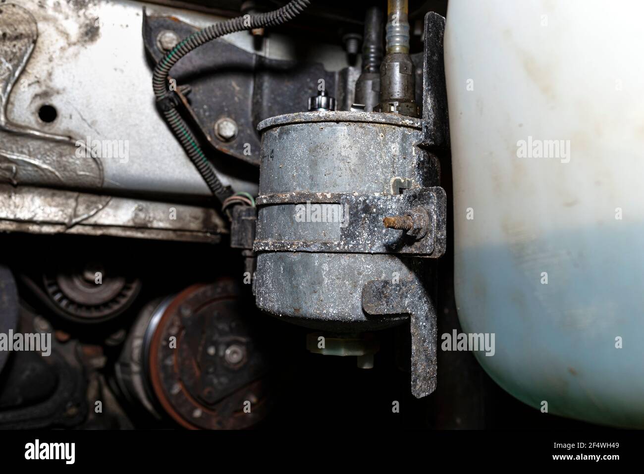 Worn fuel filter mounted and screwed on the car in the wheel arch Stock ...