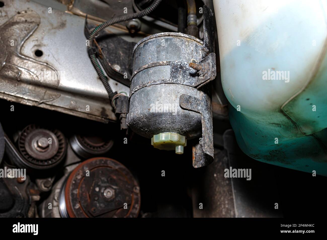 Worn fuel filter mounted and screwed on the car in the wheel arch Stock ...