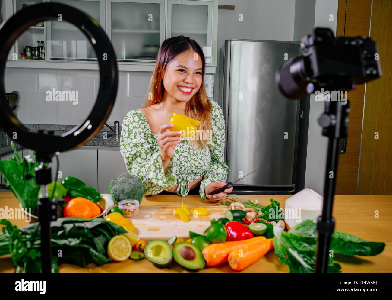 Asian woman blogger or content creator cooking and recording video ...