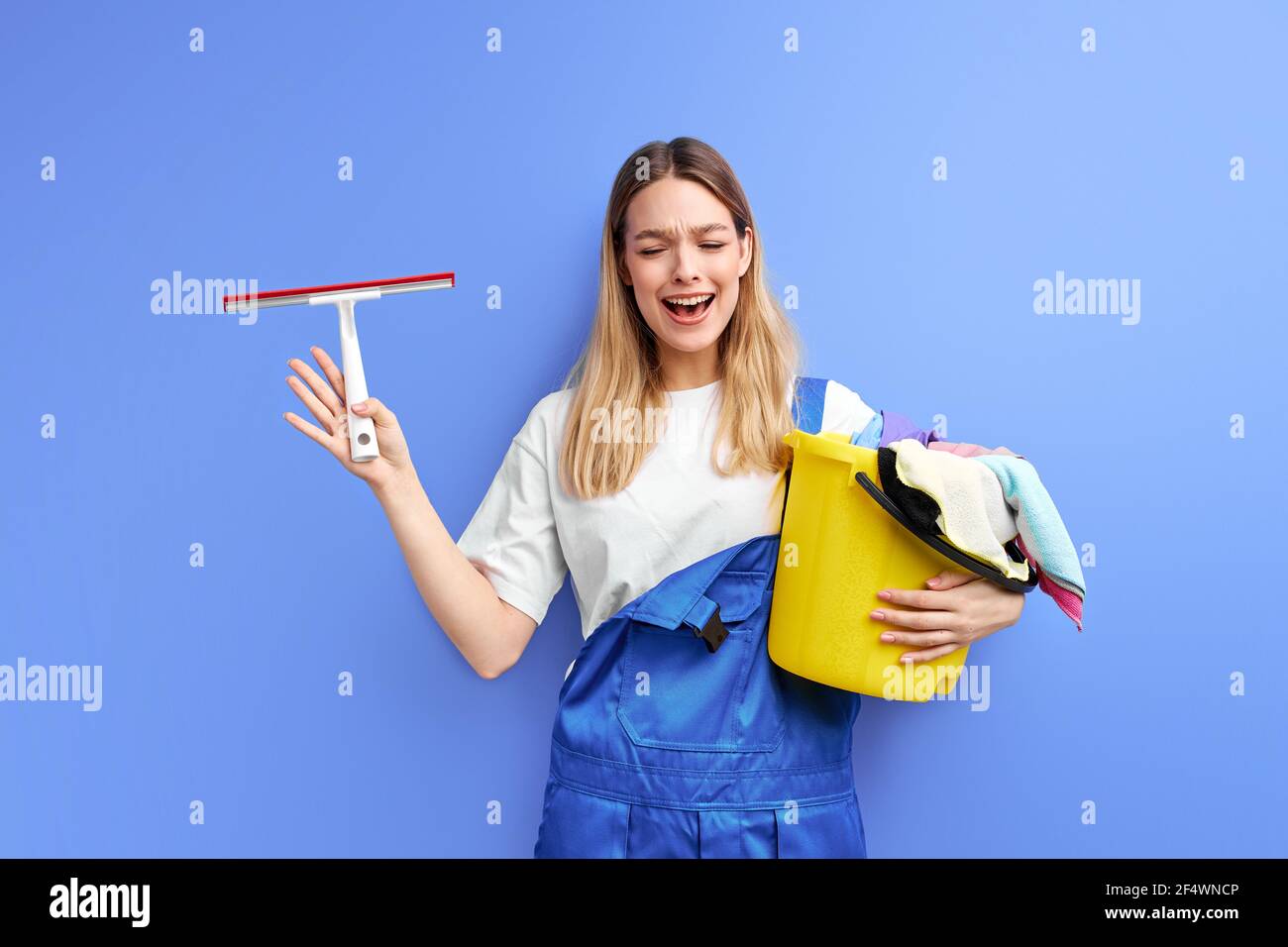crying female with cleaning supplies stand screaming by dirt in room ...