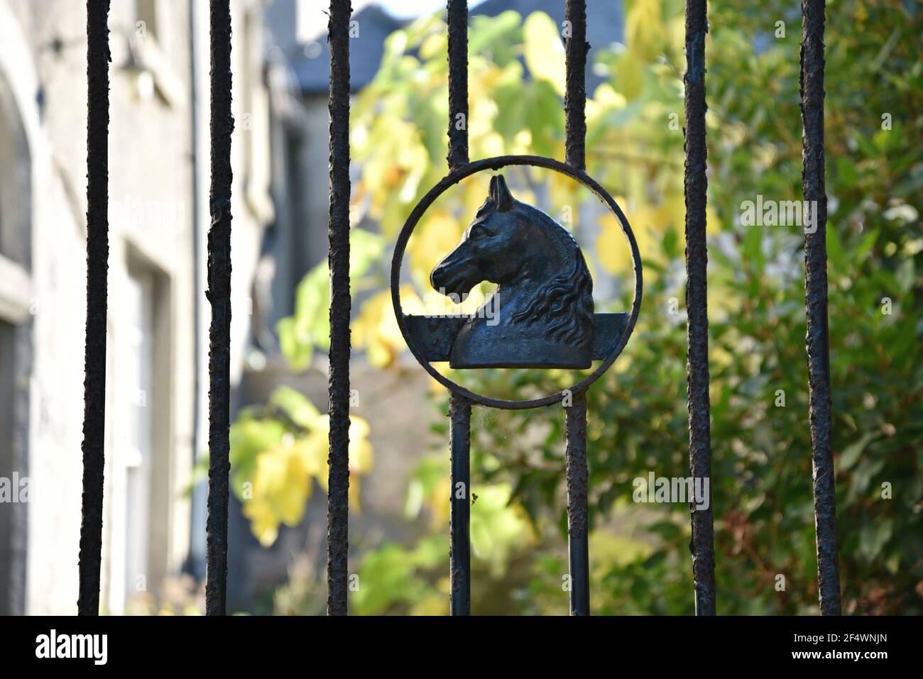 Handcrafted iron entrance gate with a horse emblem at Howth Castle in ...