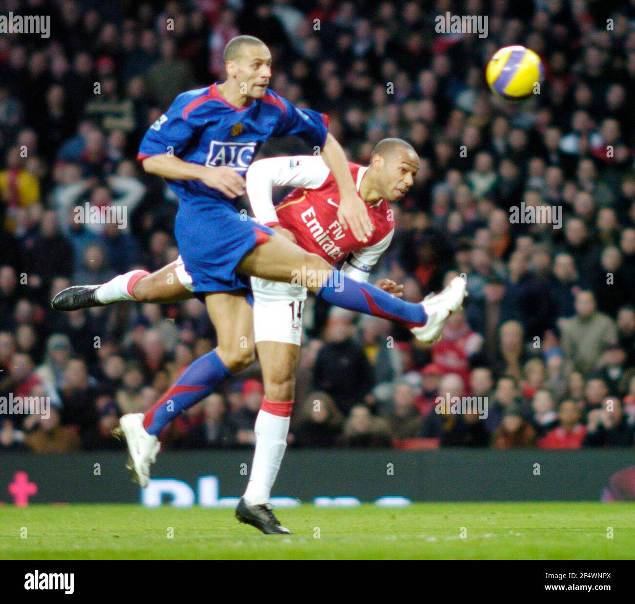 Thierry Henry and Rio Ferdinand challenge for the ball Stock Photo - Alamy