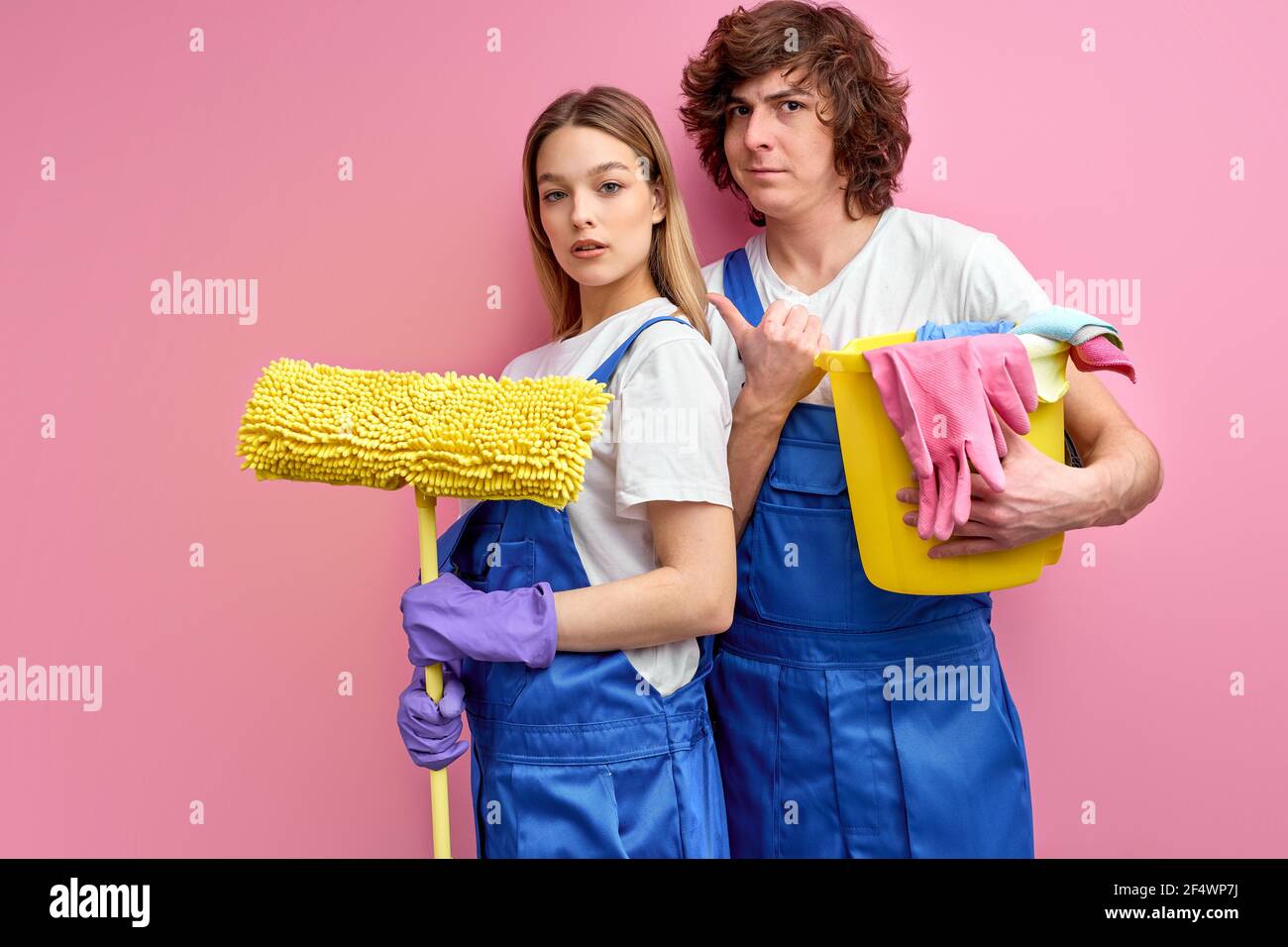 Couple cleaning , doing housework household chores together, using rags ...