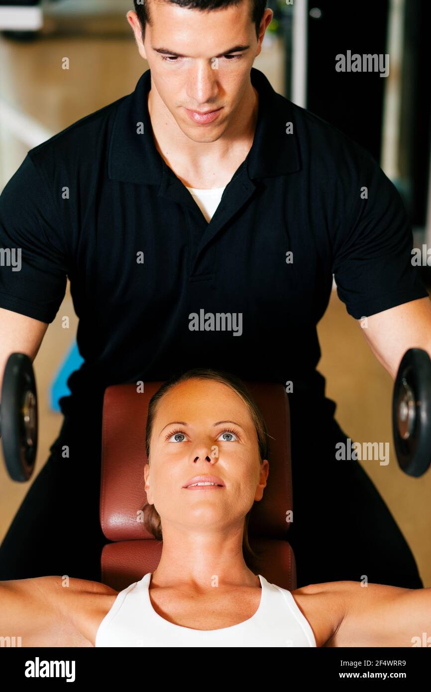 Woman does outdoor stretching with her personal trainer on a great ...
