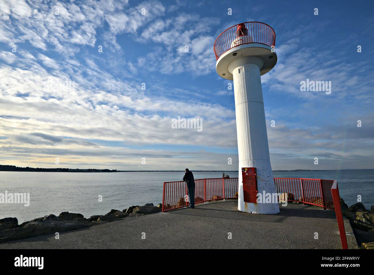 Sunset landscape with scenic view of Howth harbor Lighthouse a historic ...