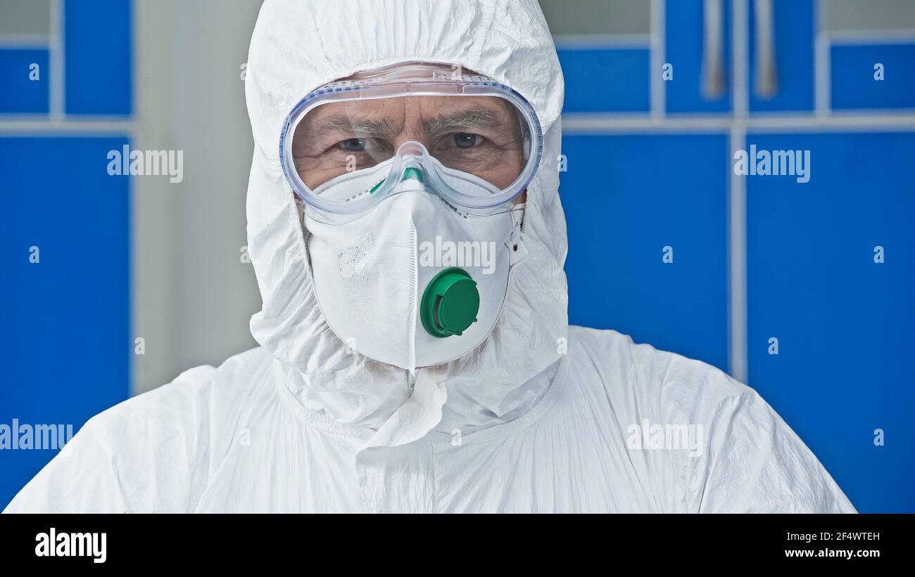 scientist in hazmat suit looking at camera in laboratory Stock Photo ...