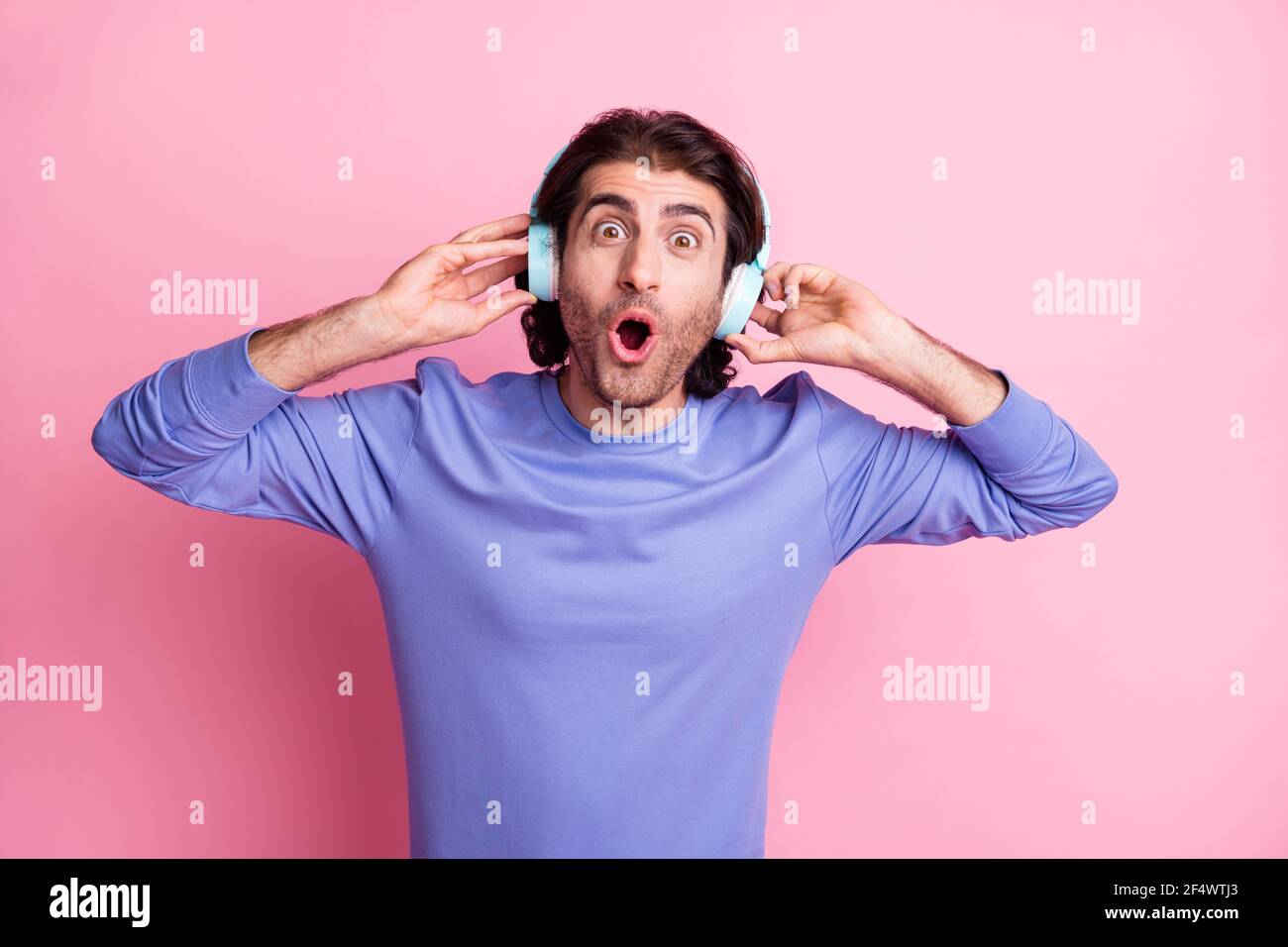 Photo of young handsome excited shocked happy amazed listen music in ...
