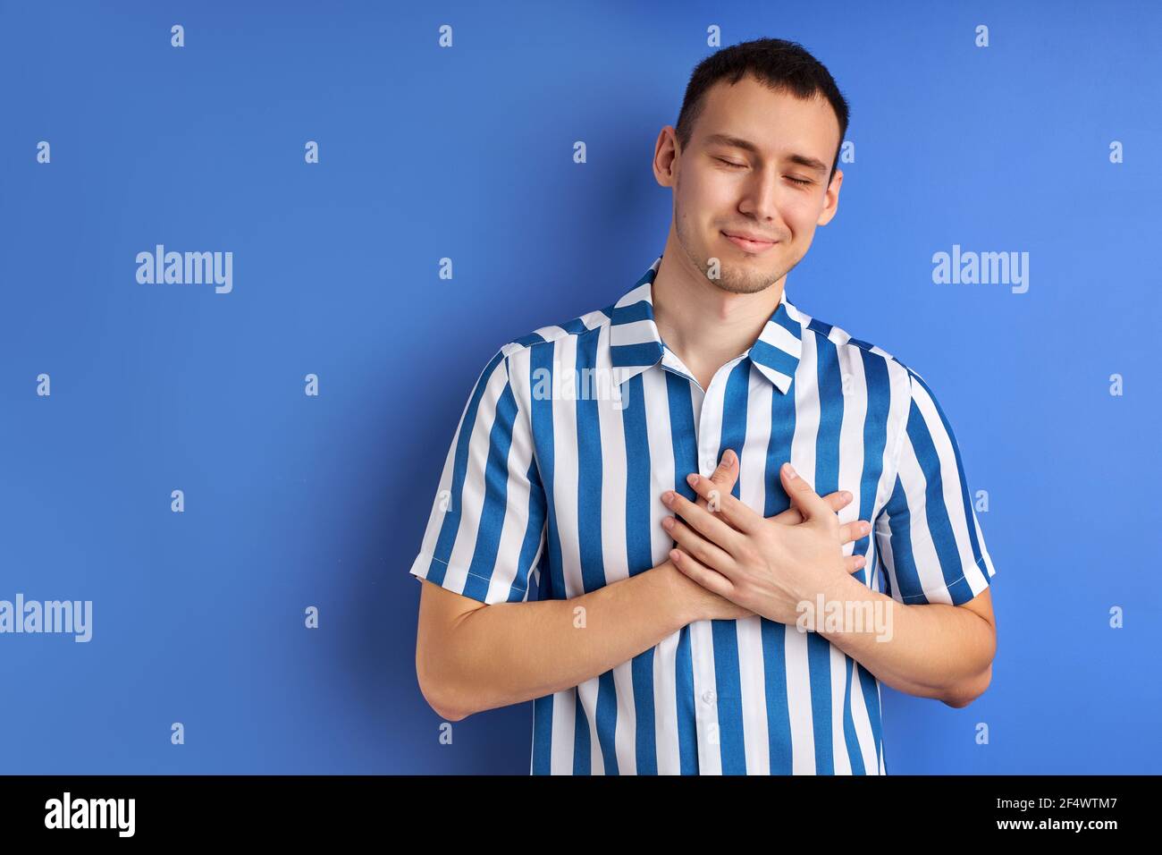 Kind Pleasant Guy Holding Hands On Chest Expressing Gratitude, Feeling ...