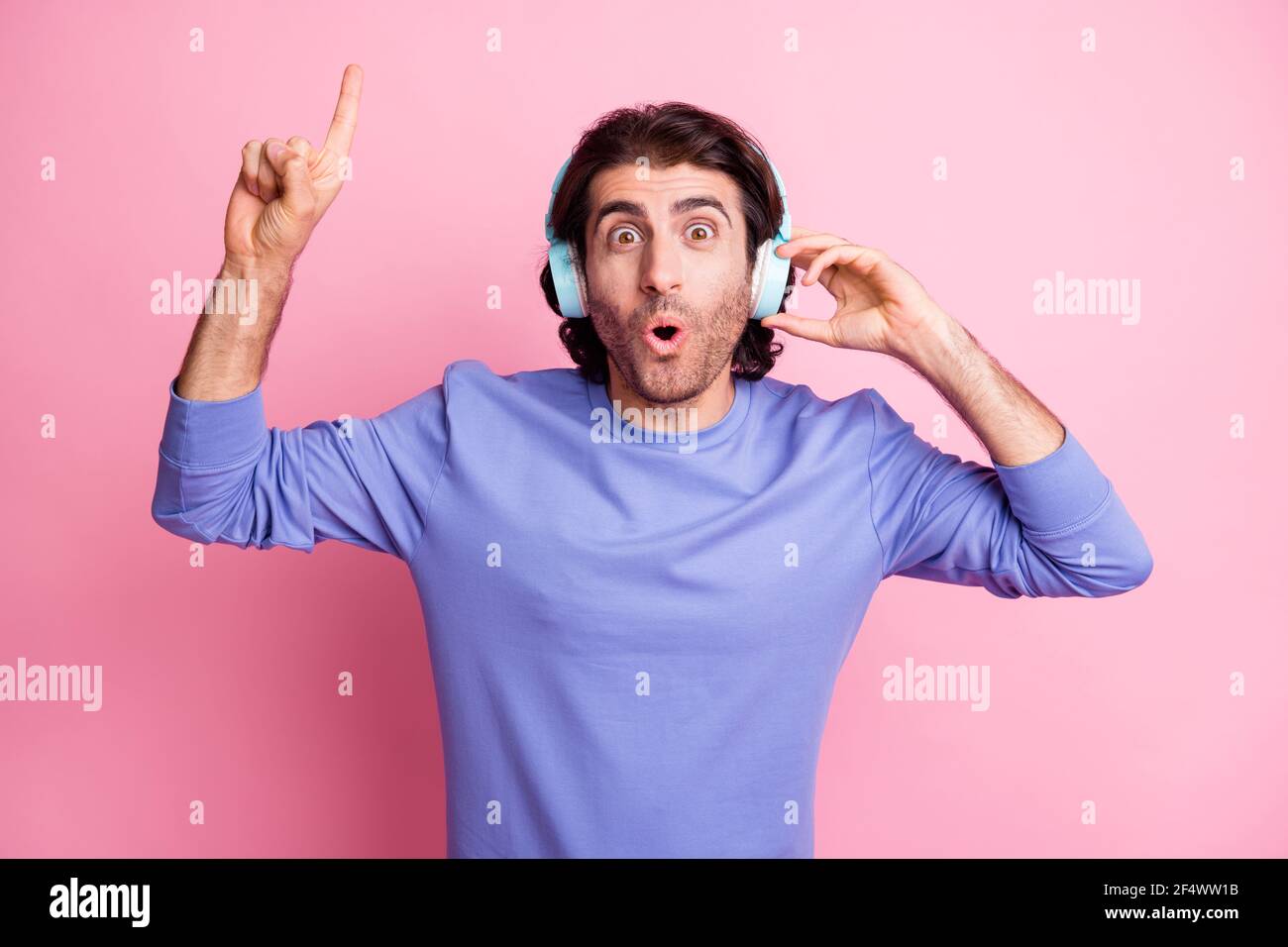 Photo of young handsome shocked amazed surprised man listen music in ...