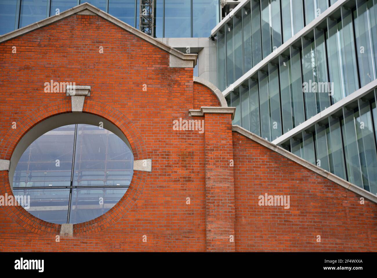 Old brick pediment with a glass building on the background in Dublin ...