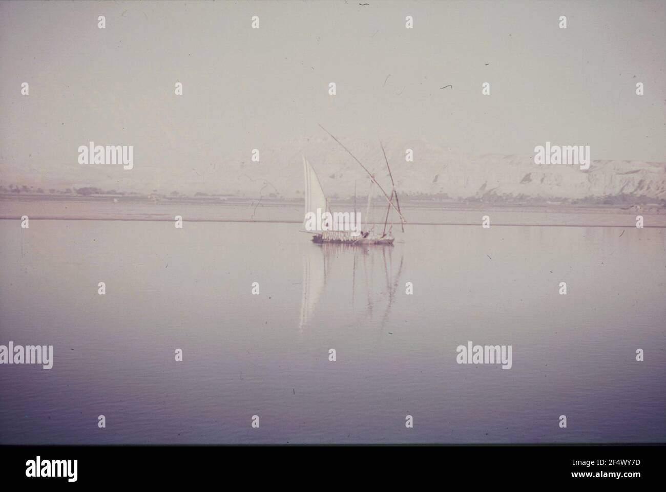 Travel photos. Sailboat in front of a coast Stock Photo - Alamy