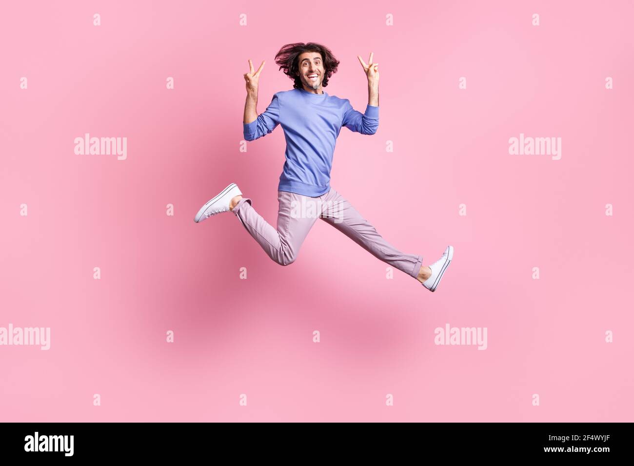 Full size photo of young excited happy joyful smiling positive man jump ...