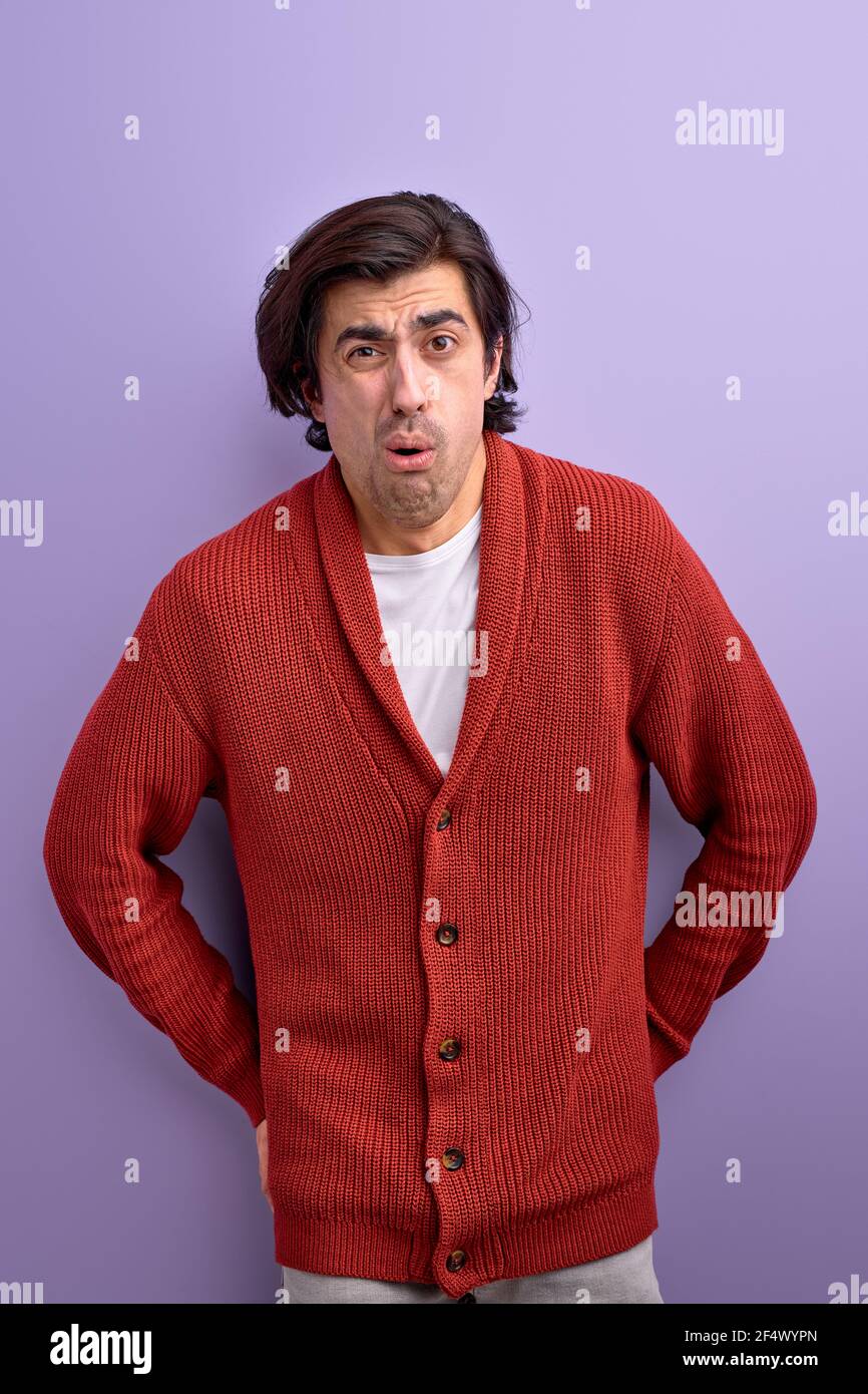 shocked man reacts on something incredible, isolated on purple ...