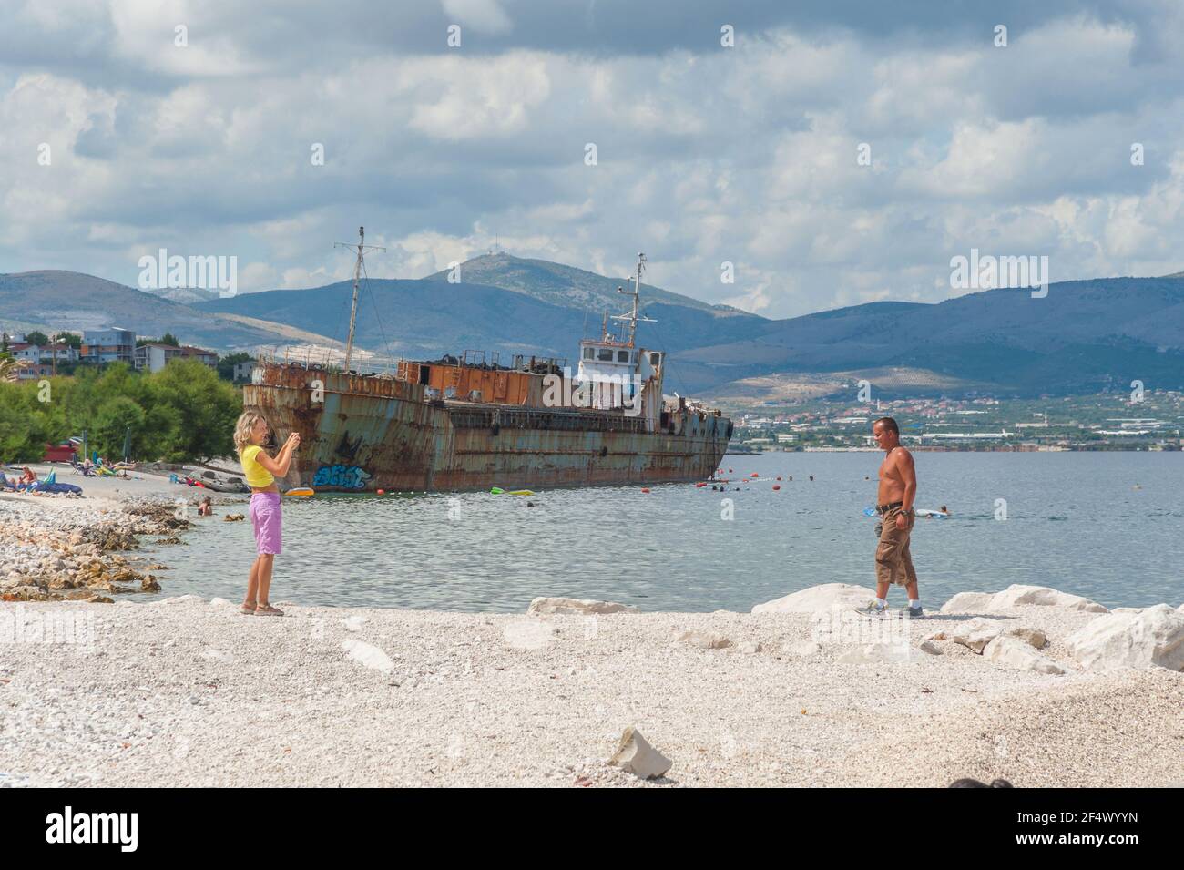 Shipwreck washed ashore spoiling Adriatic Sea coastline. Locals and ...