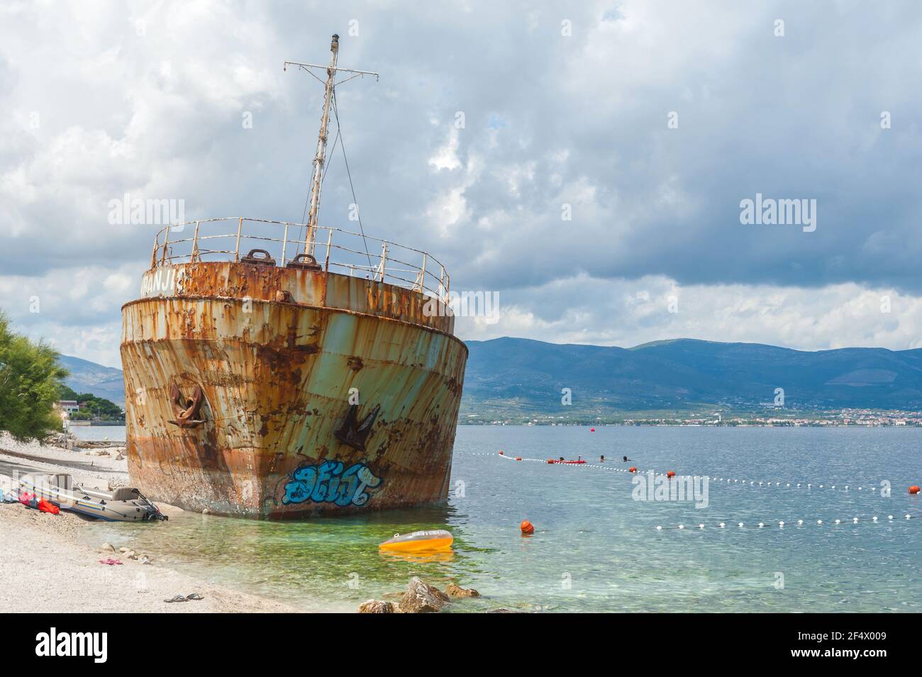 Shipwreck washed ashore spoiling Adriatic Sea coastline. Locals and ...