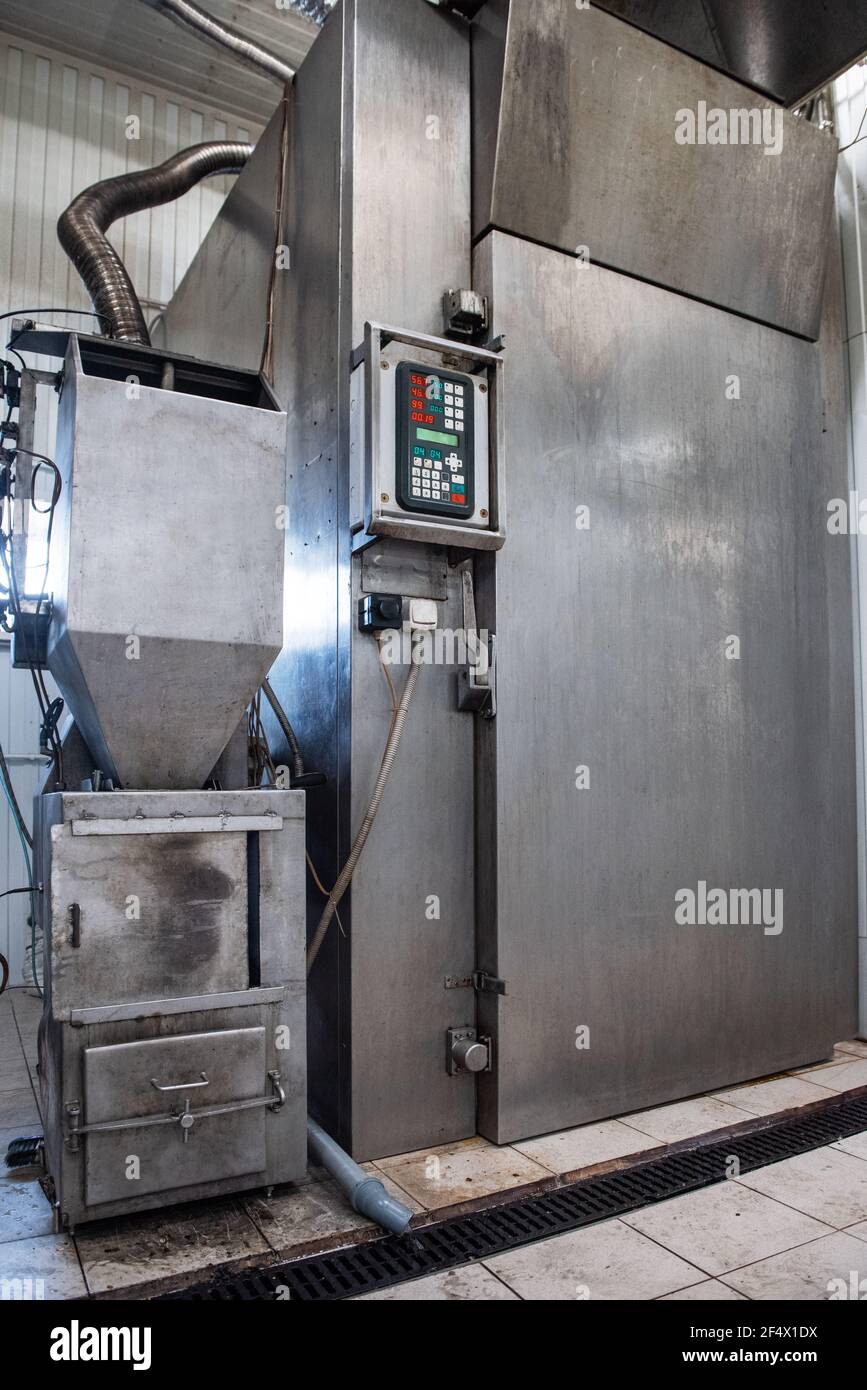 Steel smokehouse with fresh smoked fish. Smoked fish production concept ...