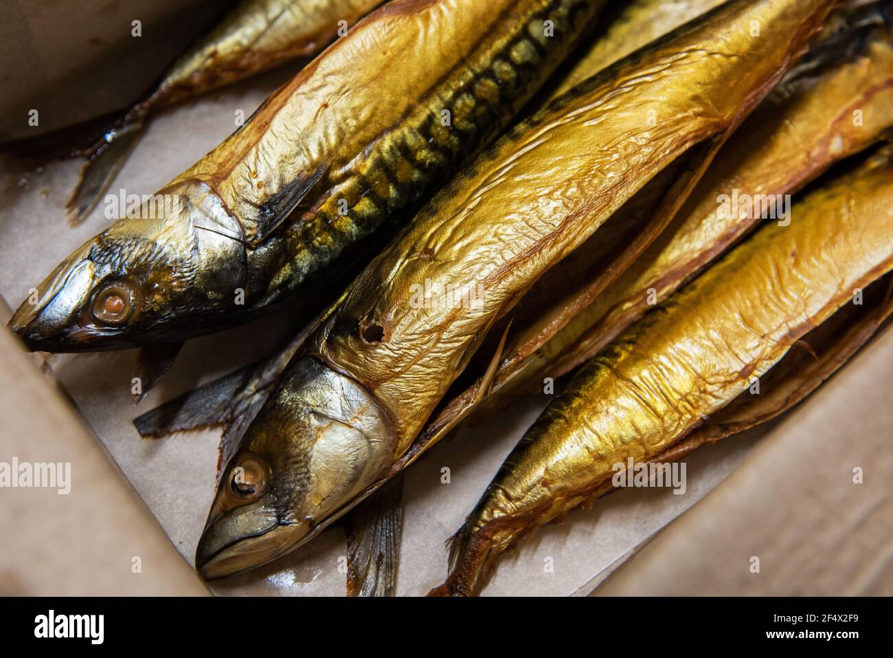 Smoked fish in craft paper box. Ready for delivery production. Smoked ...