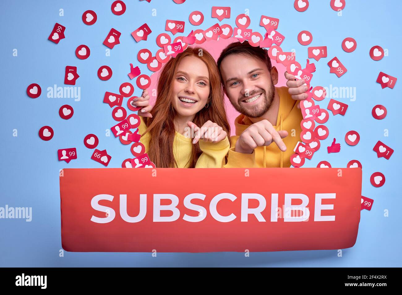 happy friends man and woman recommending to subscribe, pointing finger ...