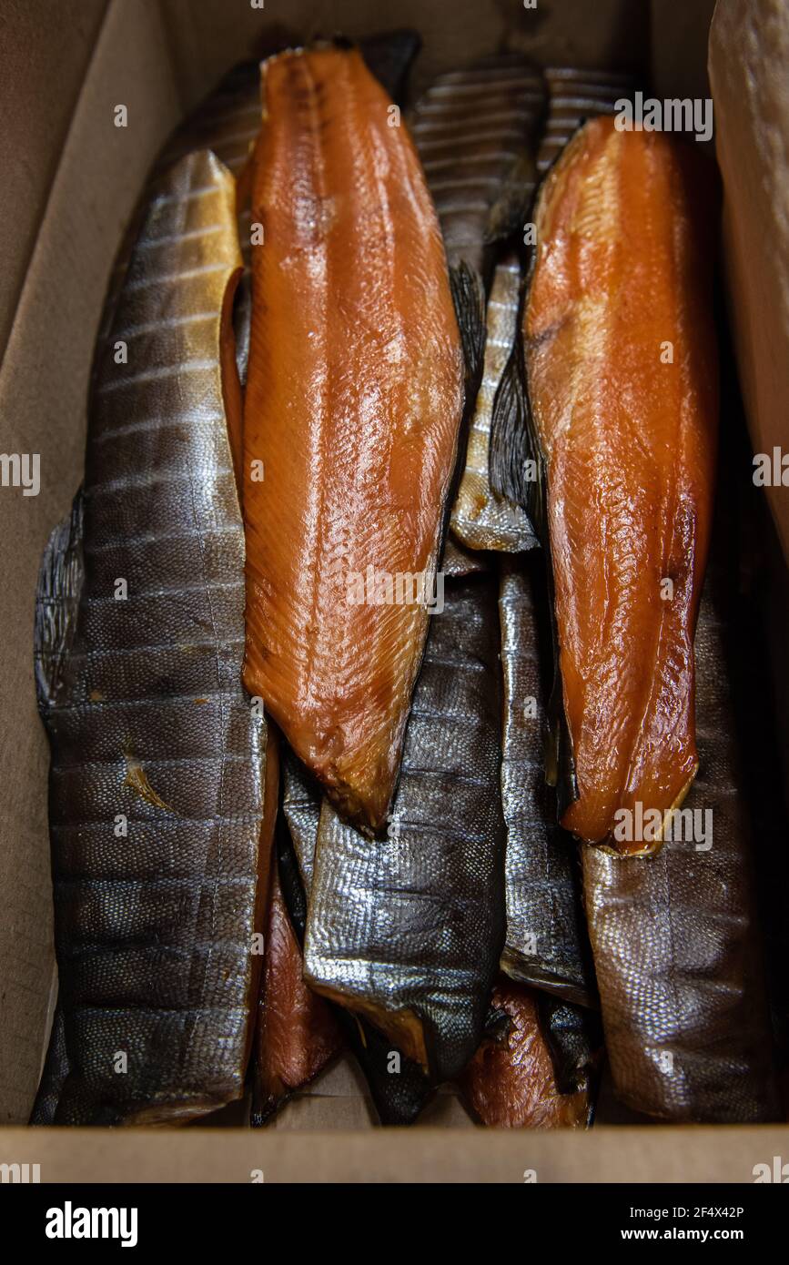 Smoked fish in craft paper box. Ready for delivery production. Smoked ...