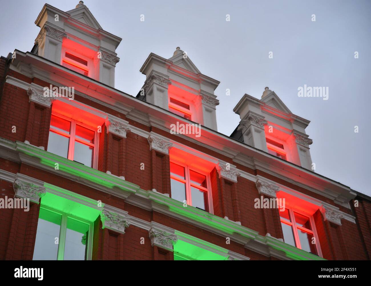 Georgian style building facade with red and green Christmas lights on ...
