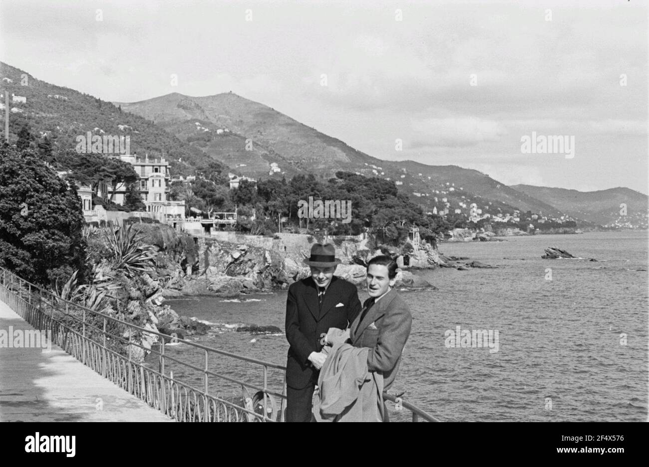 Travel Photos Italy. Two men on a waterfront Stock Photo - Alamy