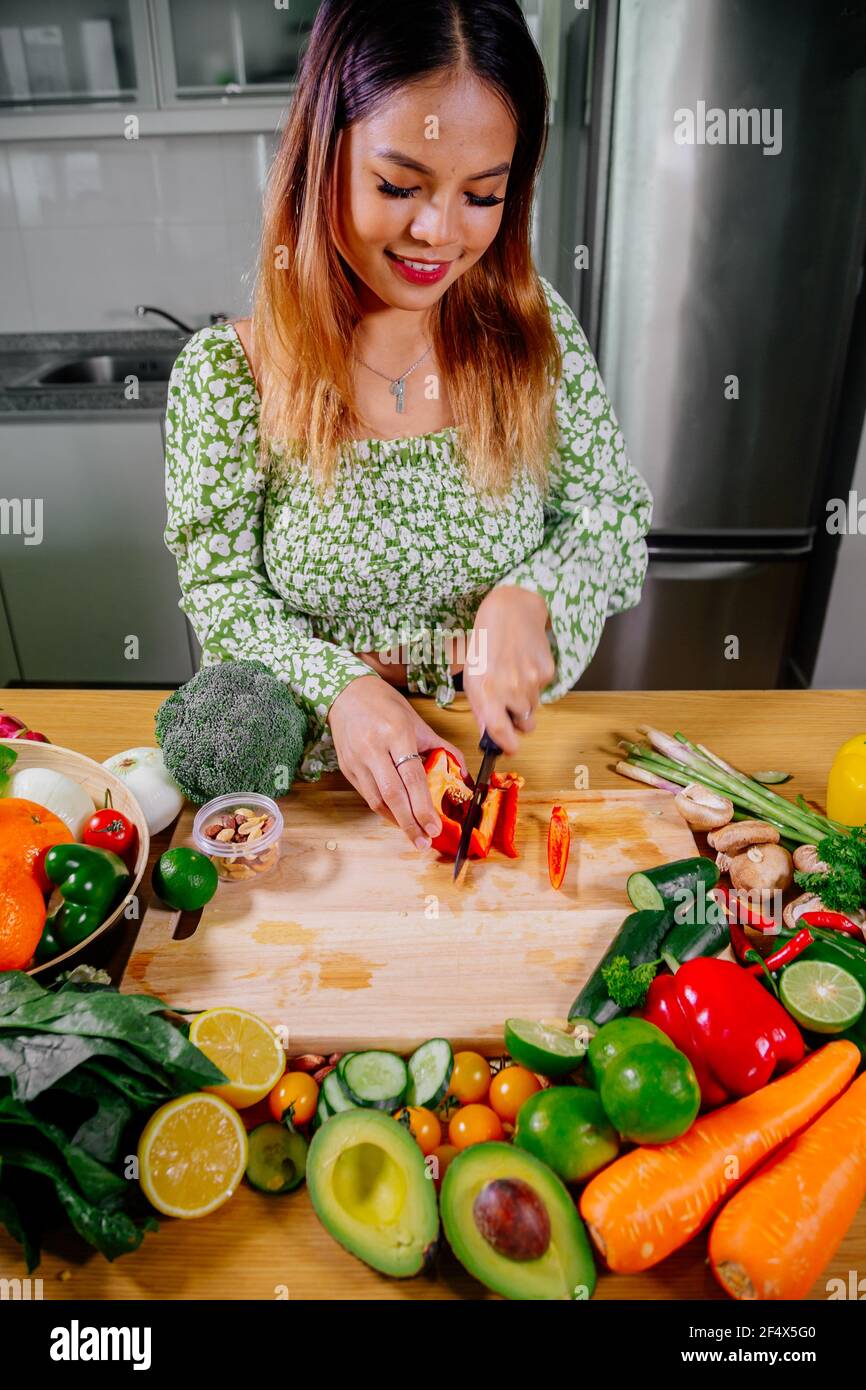 Asian girl cooking healthy vegetarian and vegan food, vegetables and ...