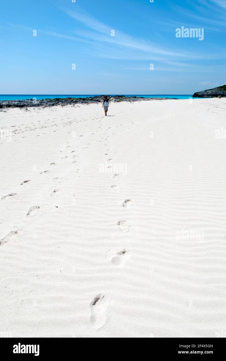 Feet marks on an endless beach on Half Moon Cay uninhabited island ...