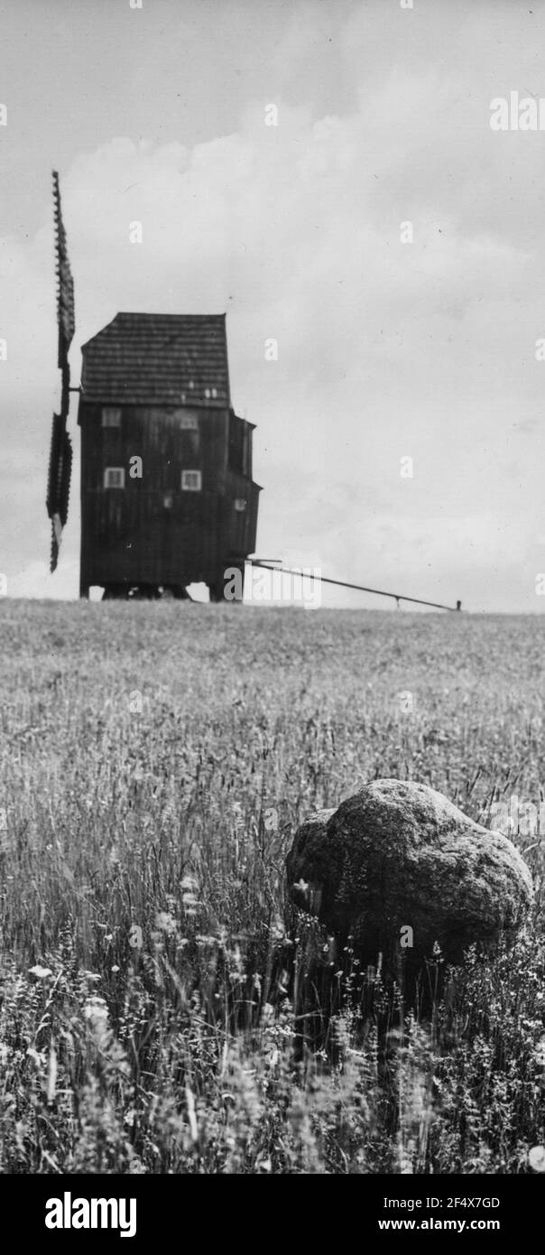 Stone cross and windmill Stock Photo - Alamy