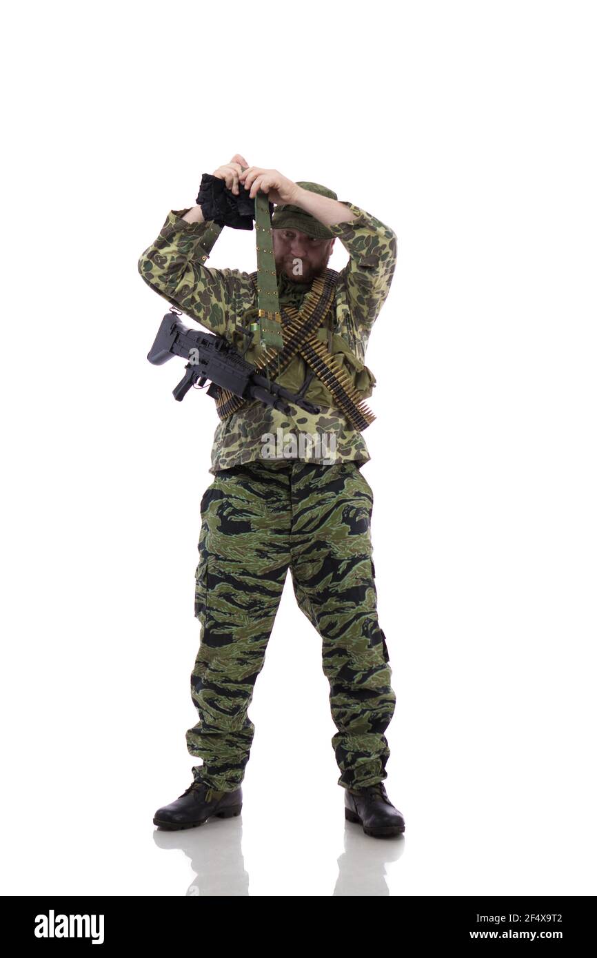 Man actor in the form of an American fur seal posing with a machine gun ...