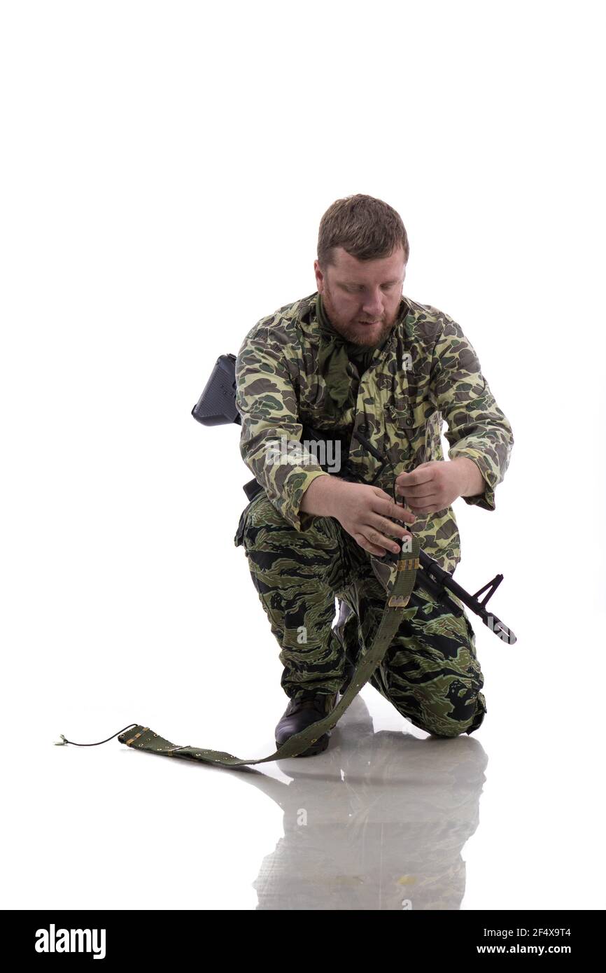 Man actor in the form of an American fur seal posing with a machine gun ...