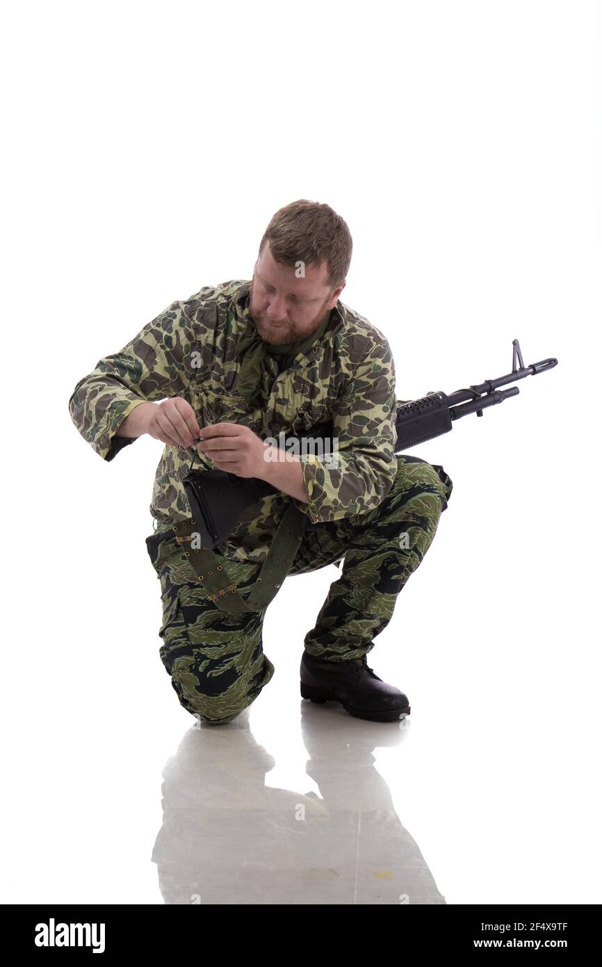 Man actor in the form of an American fur seal posing with a machine gun ...